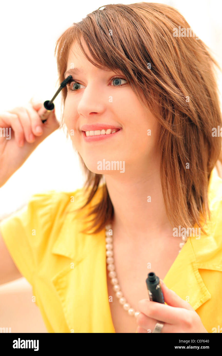 Teenager girl using mascara Stock Photo - Alamy