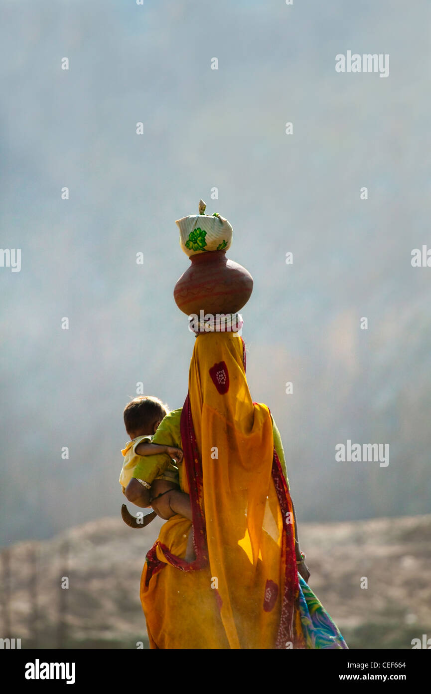 Indian woman carrying baby on hi-res stock photography and images - Alamy