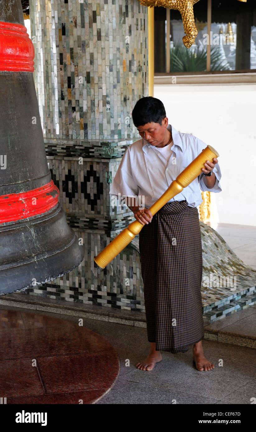 man ring ringing large bell buddhism buddhist shrine Shwedagon Pagoda ...