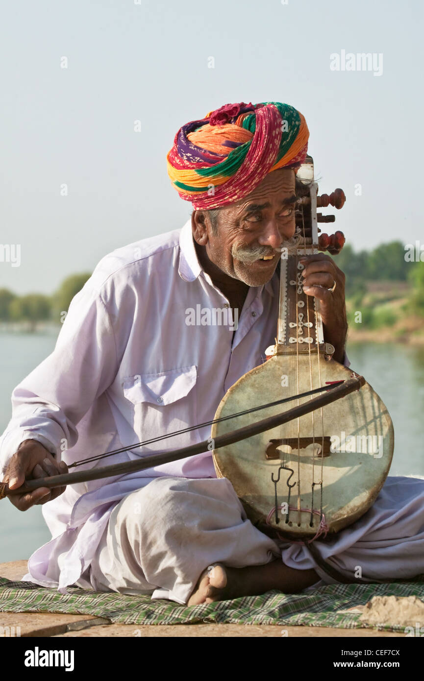 Man playing traditional musical instrument, Jaisalmer, Rajasthan, India ...