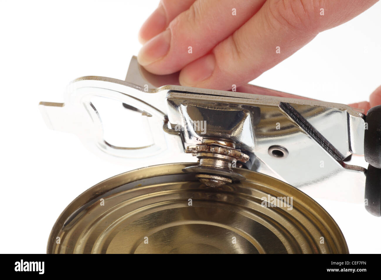hand Tin opener opening a can of food isolated on white Stock Photo - Alamy