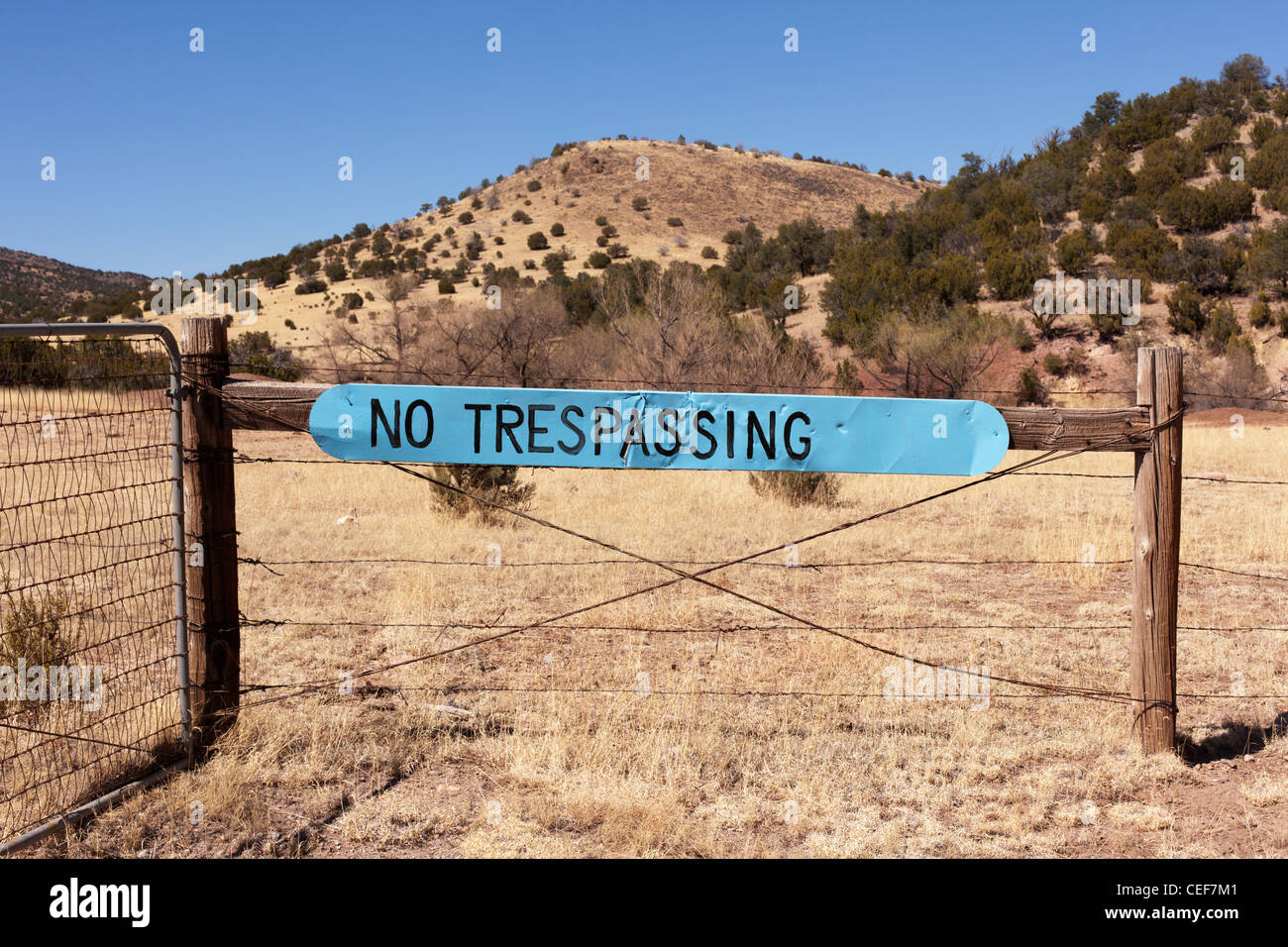 Blue no trespassing sign, rural New Mexico Stock Photo - Alamy