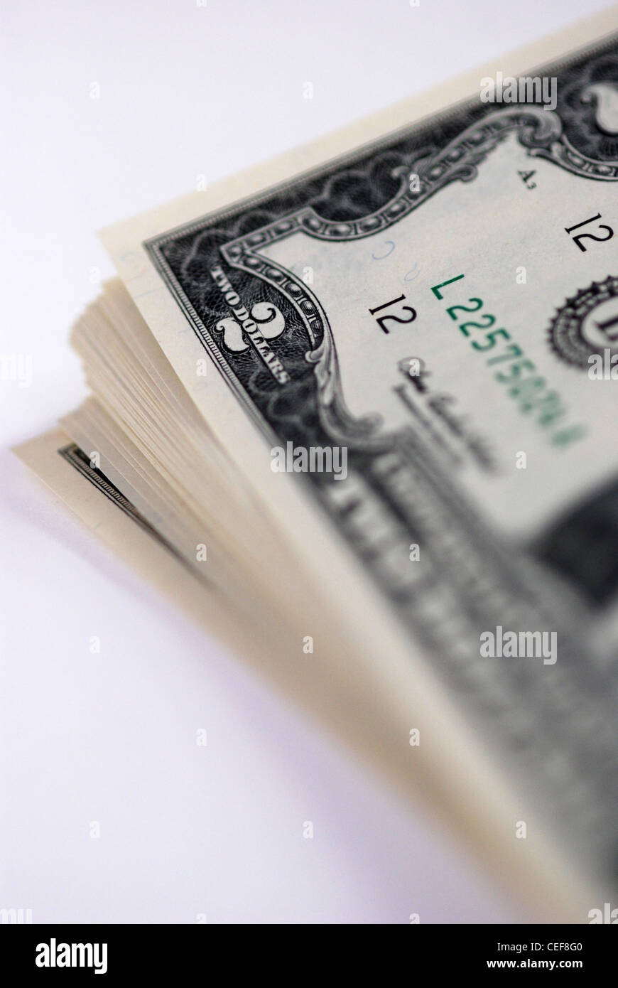 A stack of new USD two dollar bills. Close up shot on white background ...