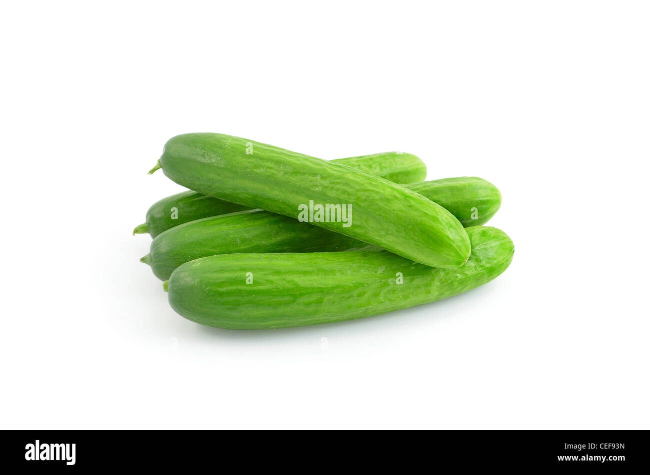 Organic mini cucumbers isolated on white background in horizontal ...