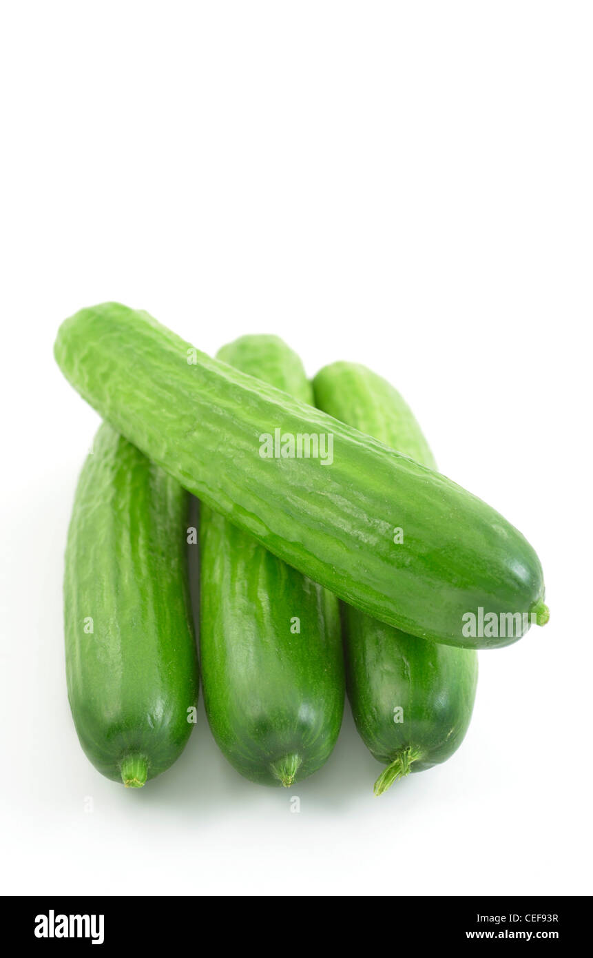 Organic mini cucumbers isolated on white background in vertical format ...