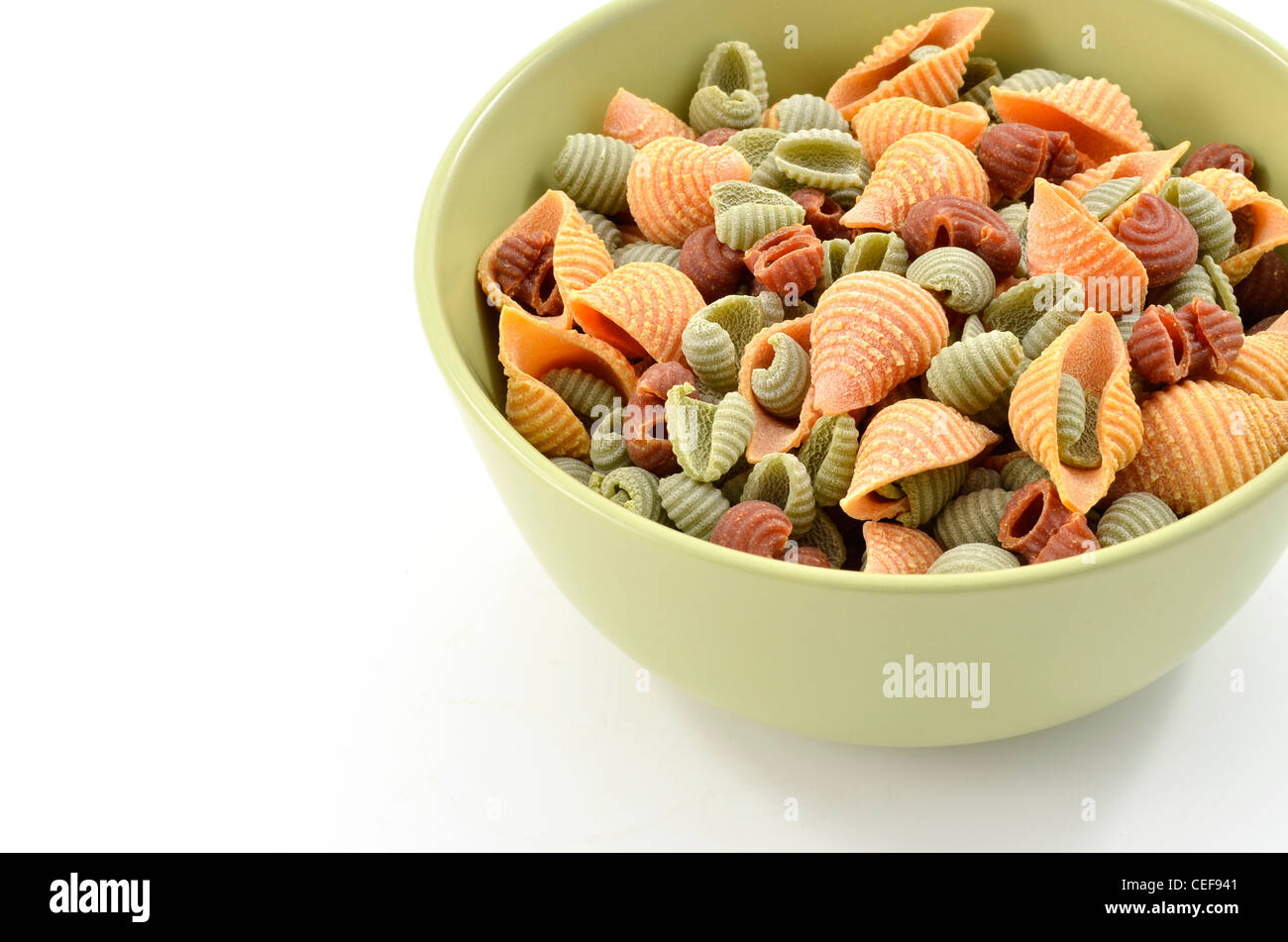 Tri-color pasta shells on white background in horizontal format Stock ...
