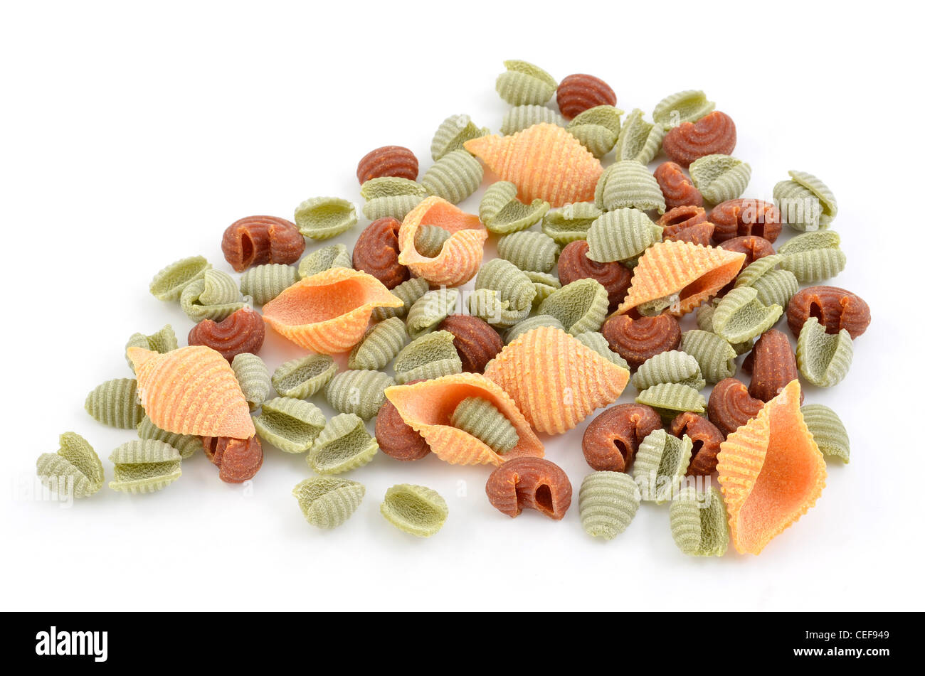 Tri-color pasta shells on white background in horizontal format Stock ...