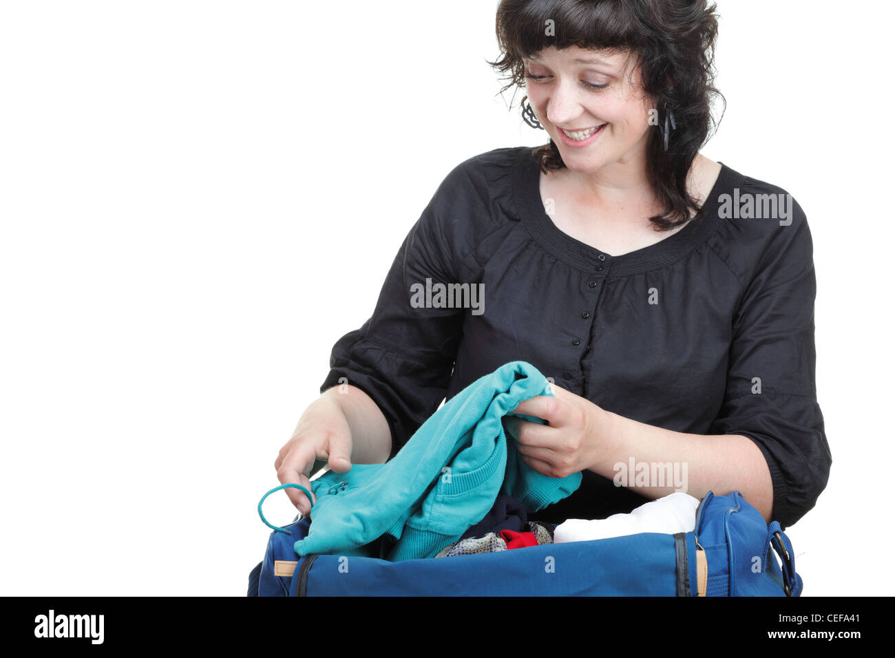 woman crammed full of clothes in black and blue shoulder bag isolated ...