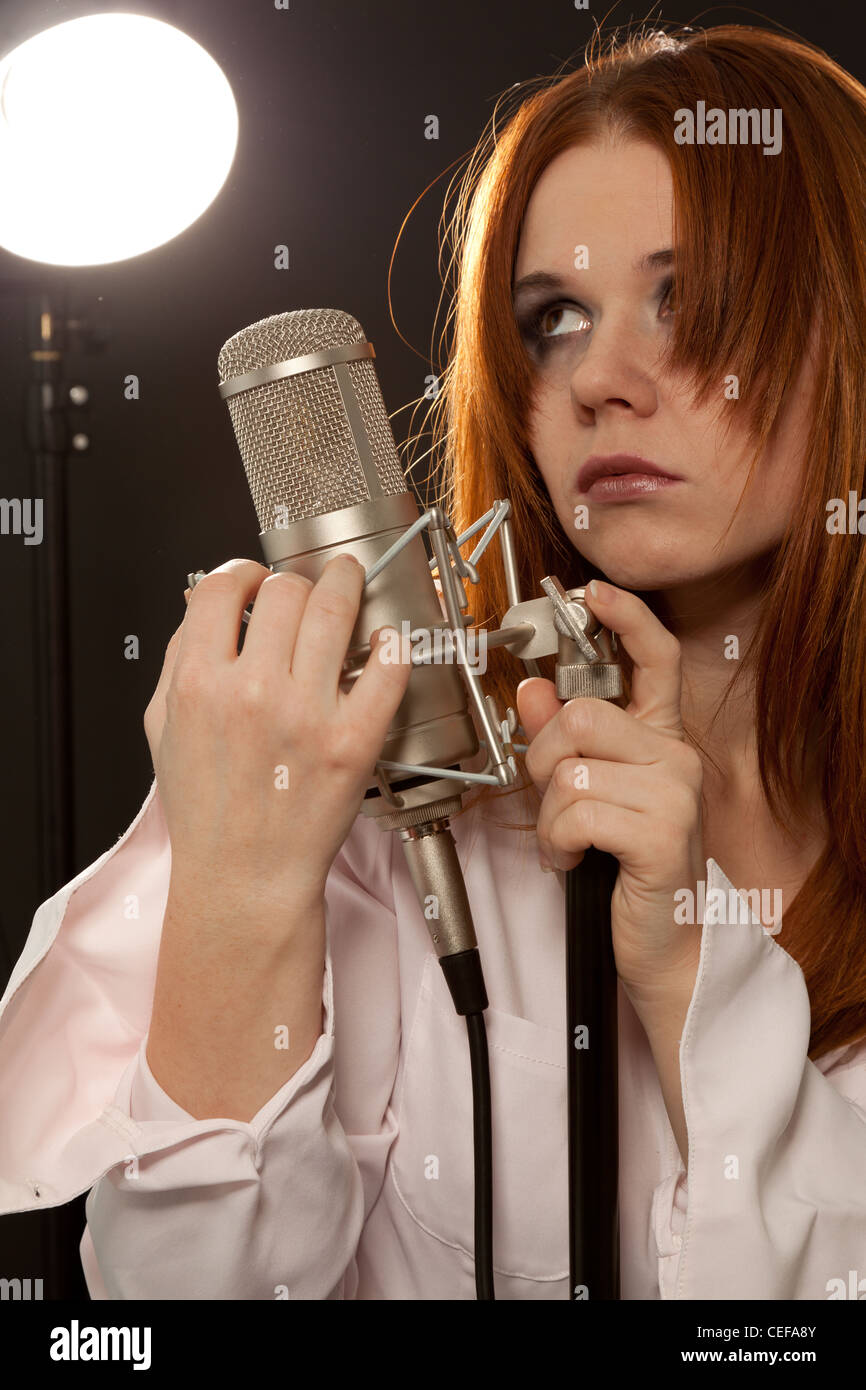 Young rock and roll singer with microphone Stock Photo - Alamy