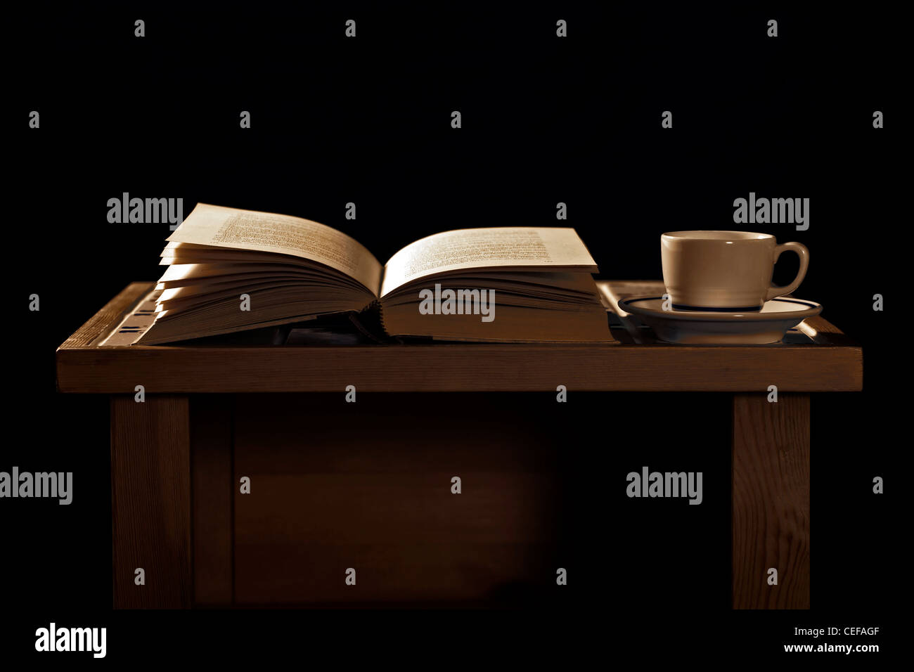 old wooden table with an open book and a cup of coffee Stock Photo - Alamy