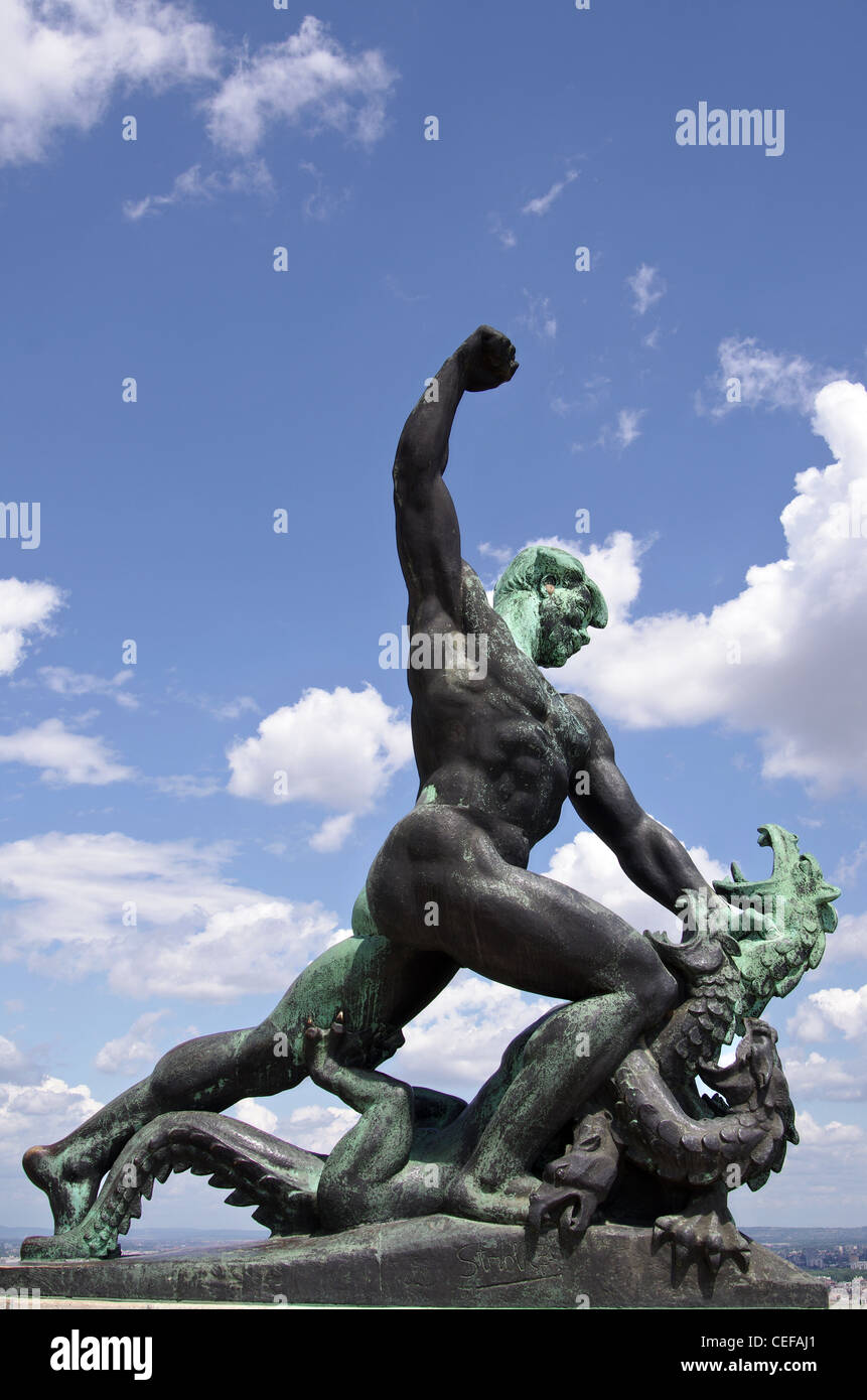 details of a bronze statue of a mythological figure fighting a dragon ...