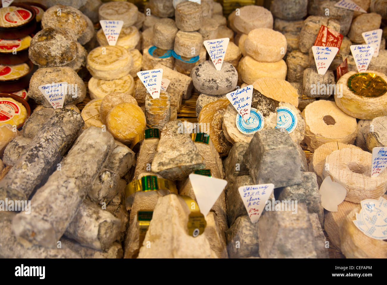 A variety of French cheeses displayed in a shop in Paris France Stock ...
