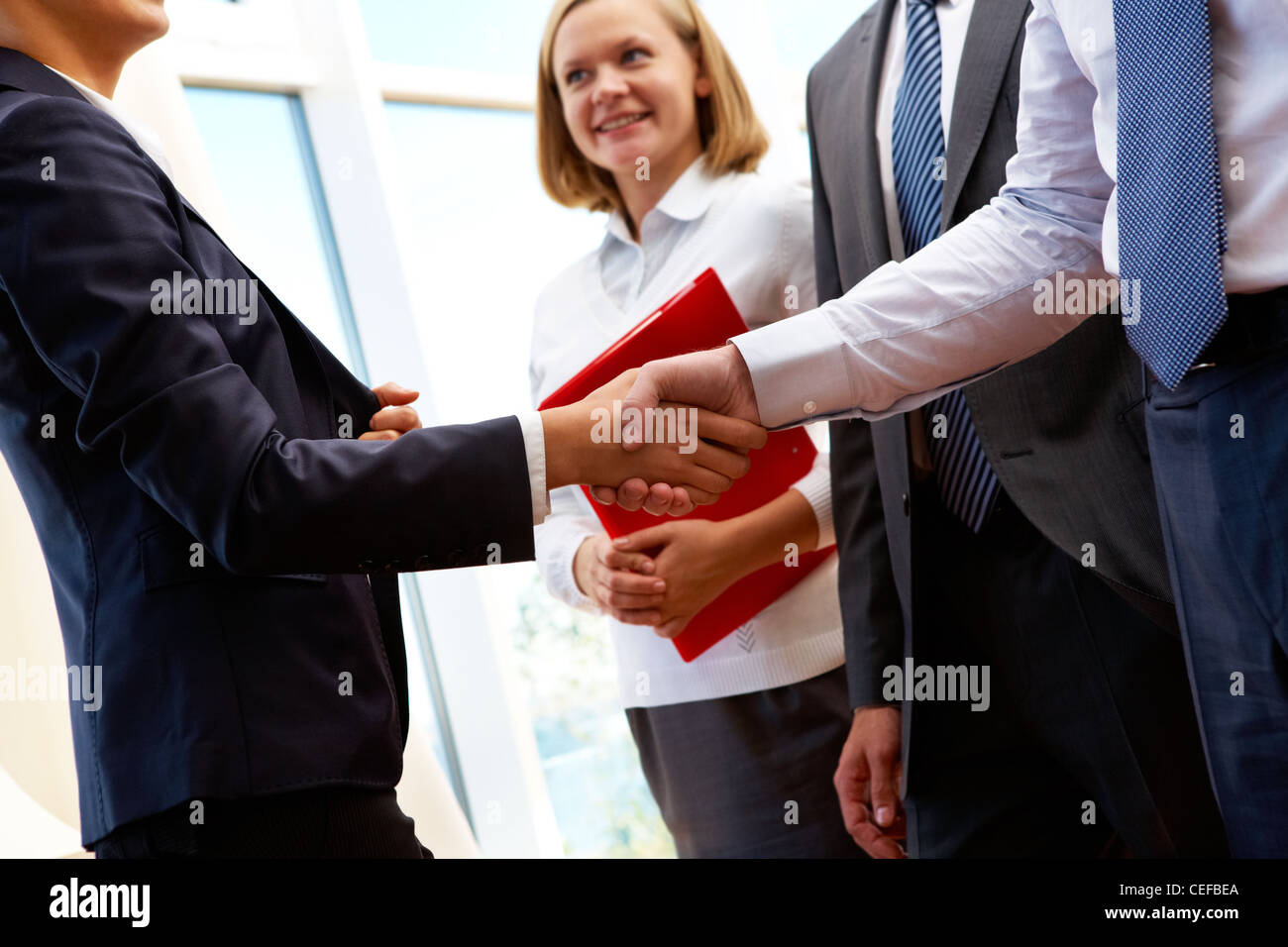 Image of business partners handshake after signing new contract Stock ...
