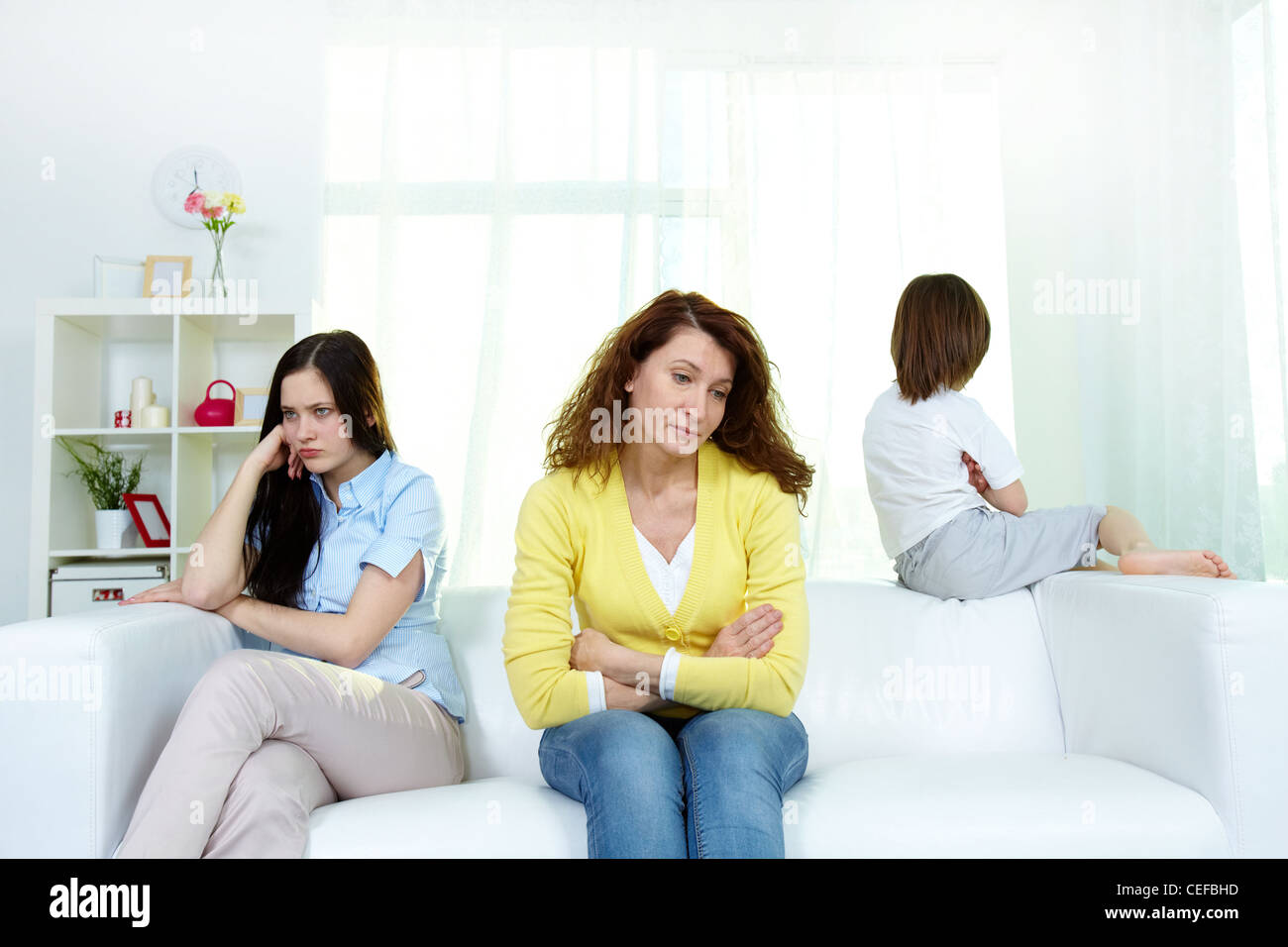 Photo Of Sad Woman And Her Teenage Daughter Sitting On Sofa During