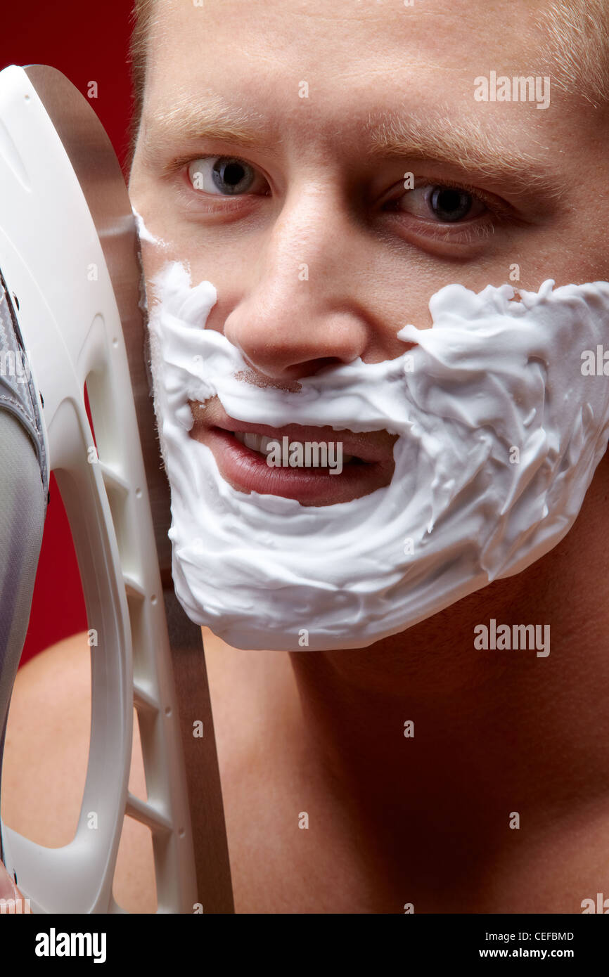 Handsome guy shaving with a skate blade Stock Photo - Alamy