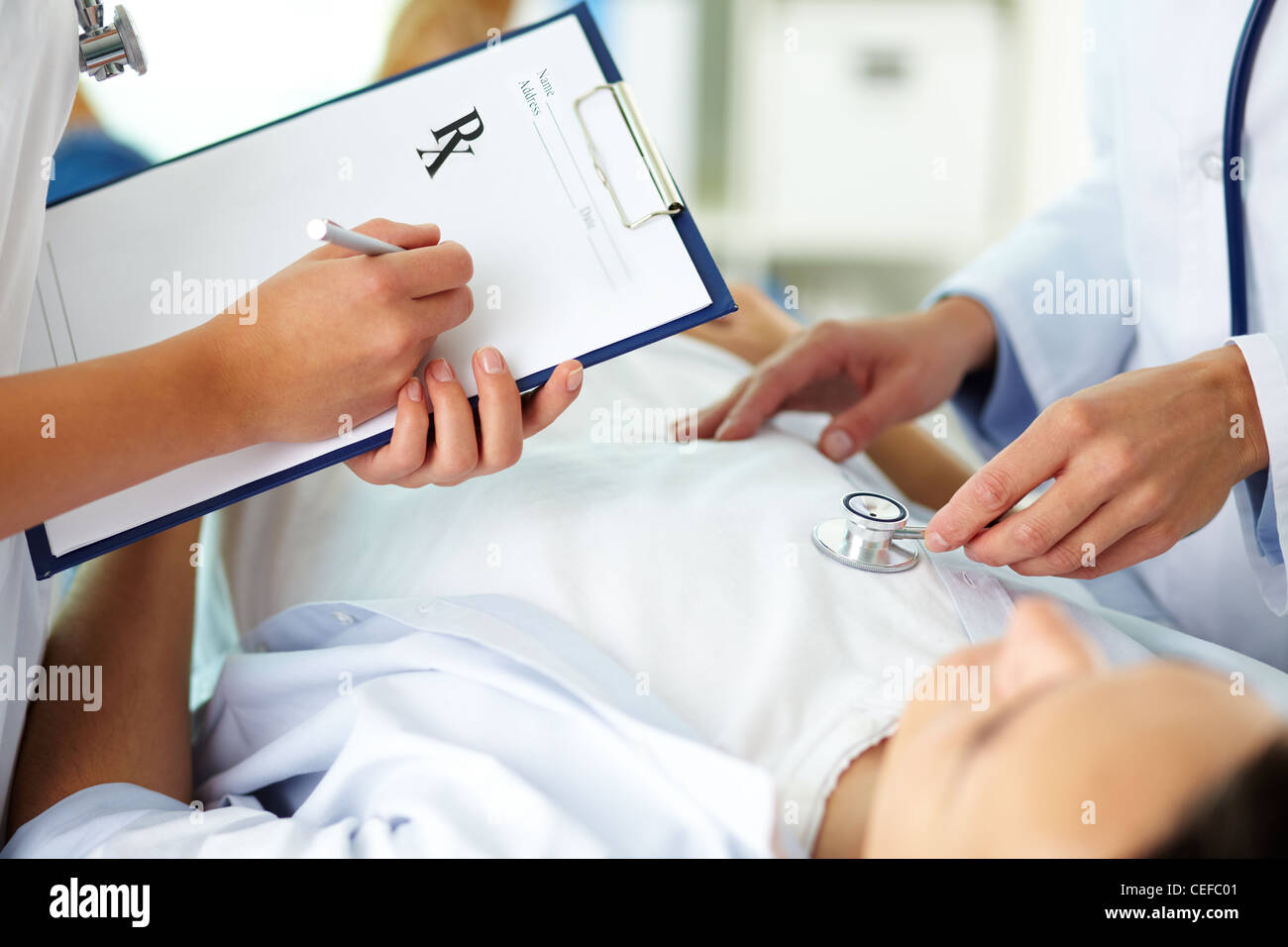 Close-up of female doctors during medical treatment of patient in ...
