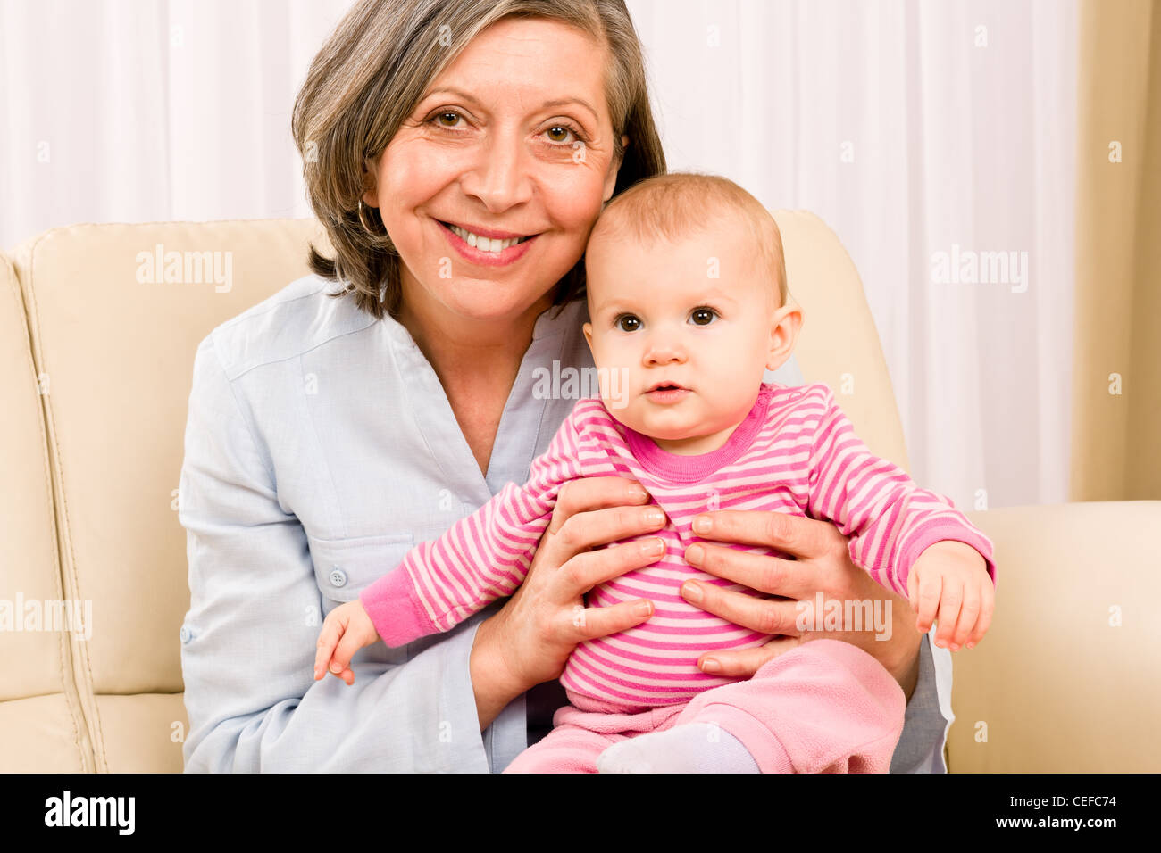 Senior woman hold little baby girl cute smiling close-up Stock Photo ...