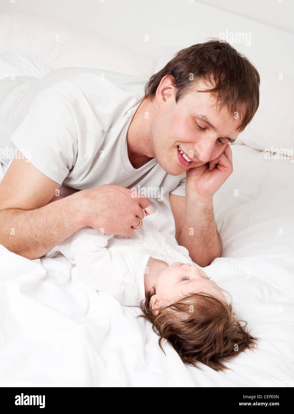 happy young father with his baby in bed at home Stock Photo - Alamy