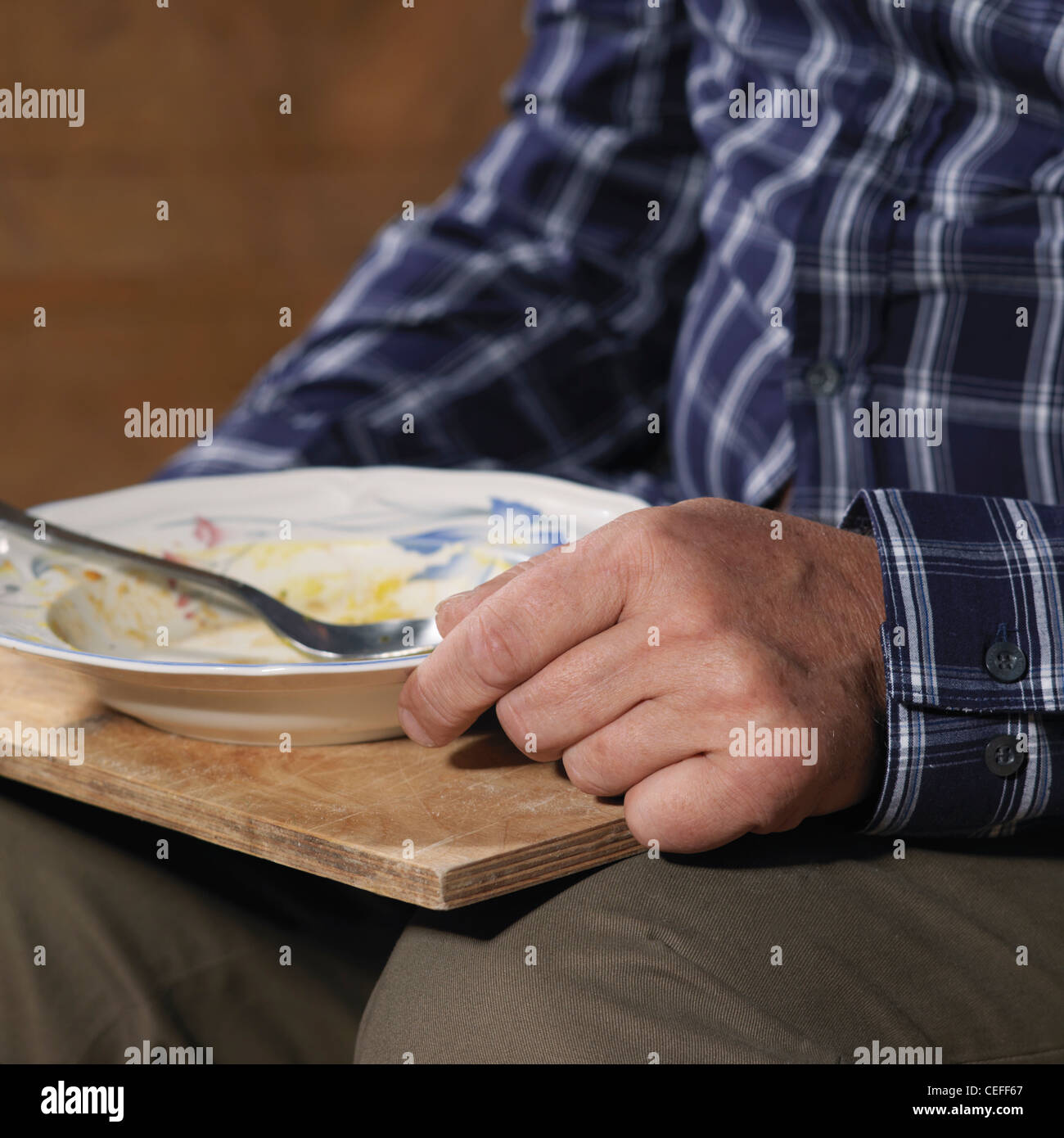 Older man eating on tray Stock Photo - Alamy