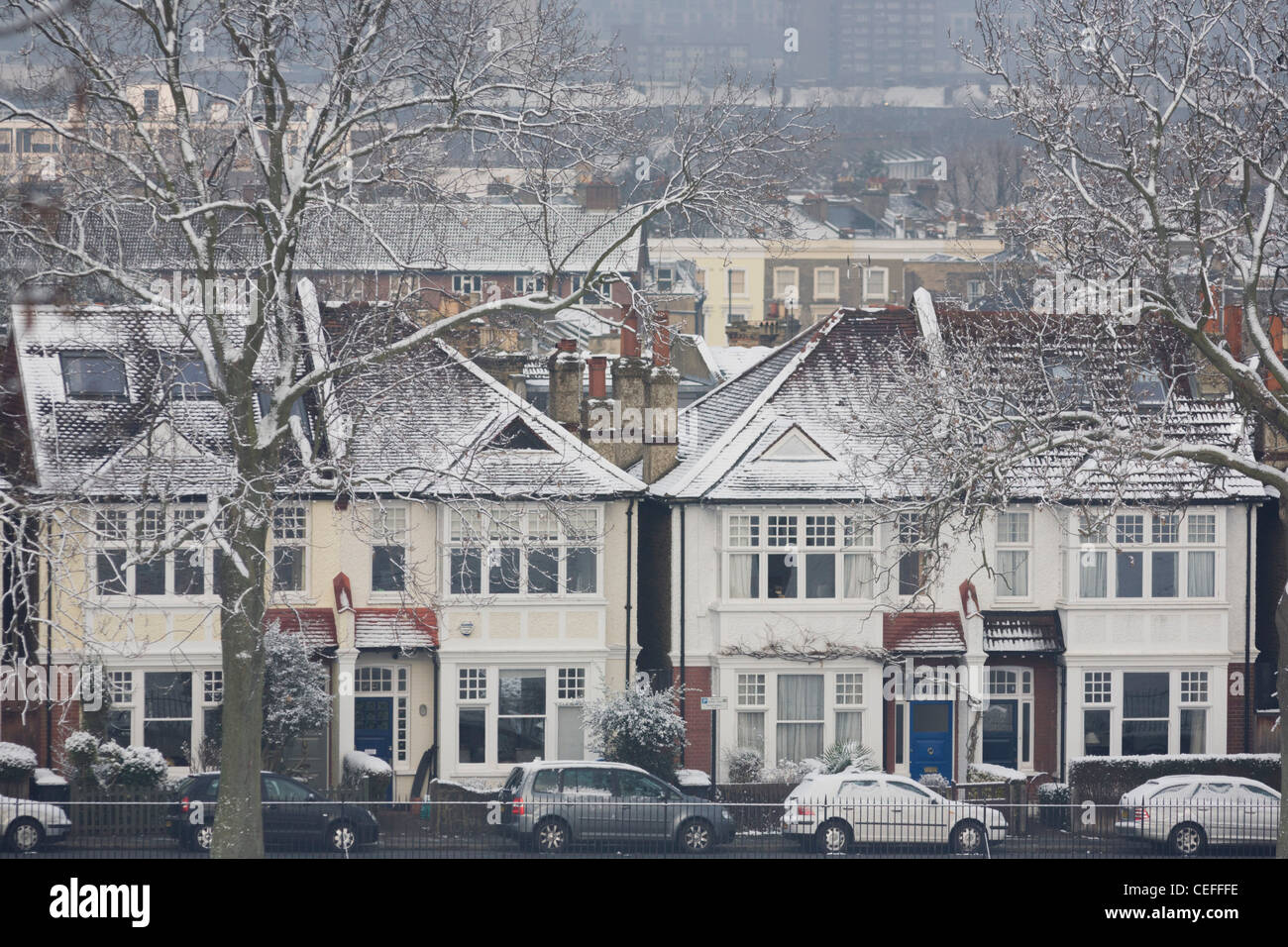 Snow covered rooftops of south London residential houses, some with ...