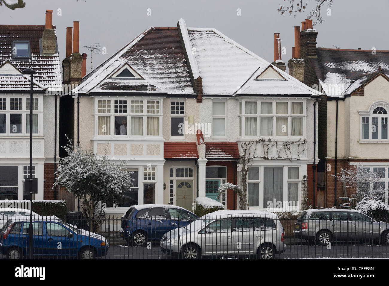 Snow covered rooftops of south London residential houses, some with ...