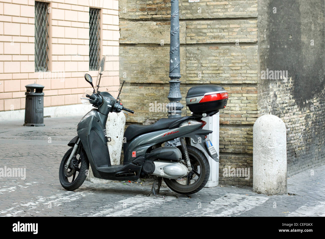 Motor Bike parked up by a lamp post on a zebra crossing Stock Photo - Alamy