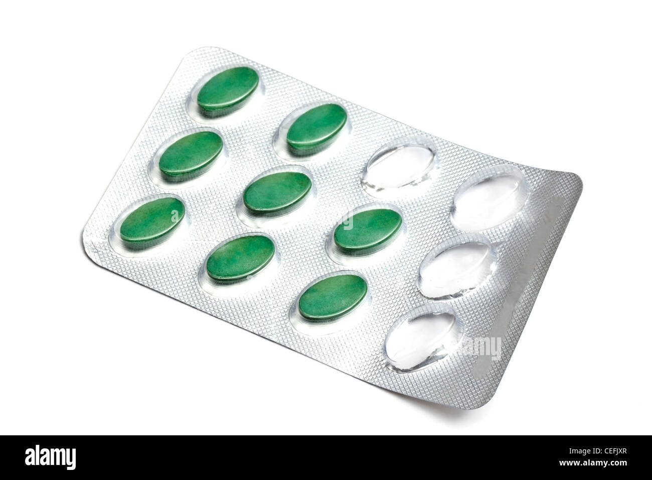 Green pills isolated on white background Stock Photo - Alamy