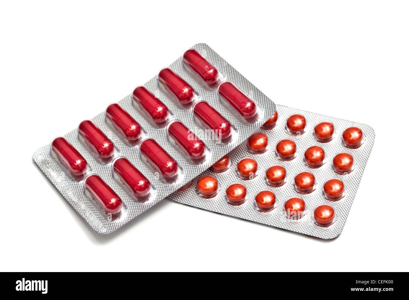 Red pills and capsules isolated on white background Stock Photo - Alamy