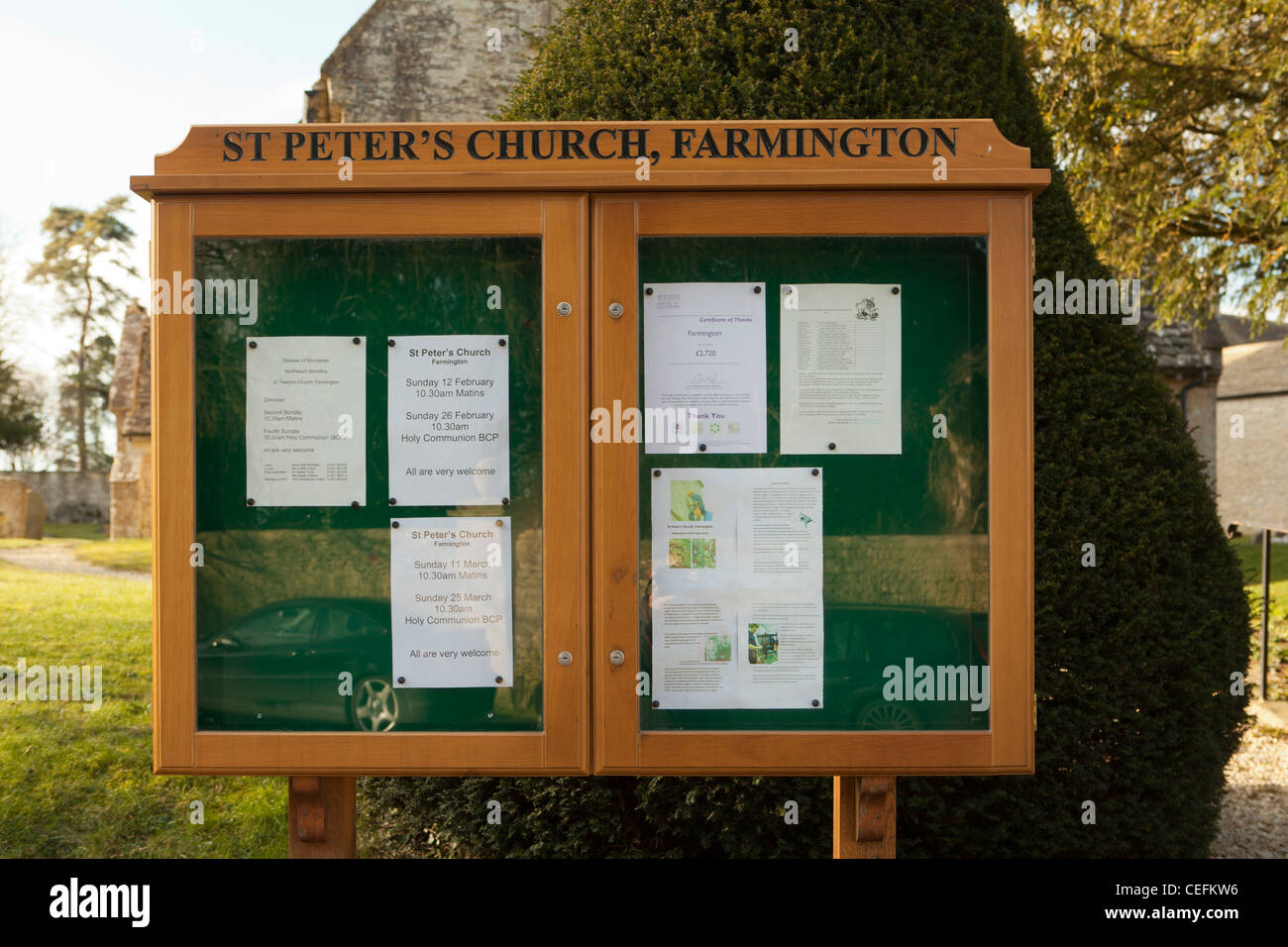 Sign in the churchyard of St Peter's Church in the Cotswold village of ...