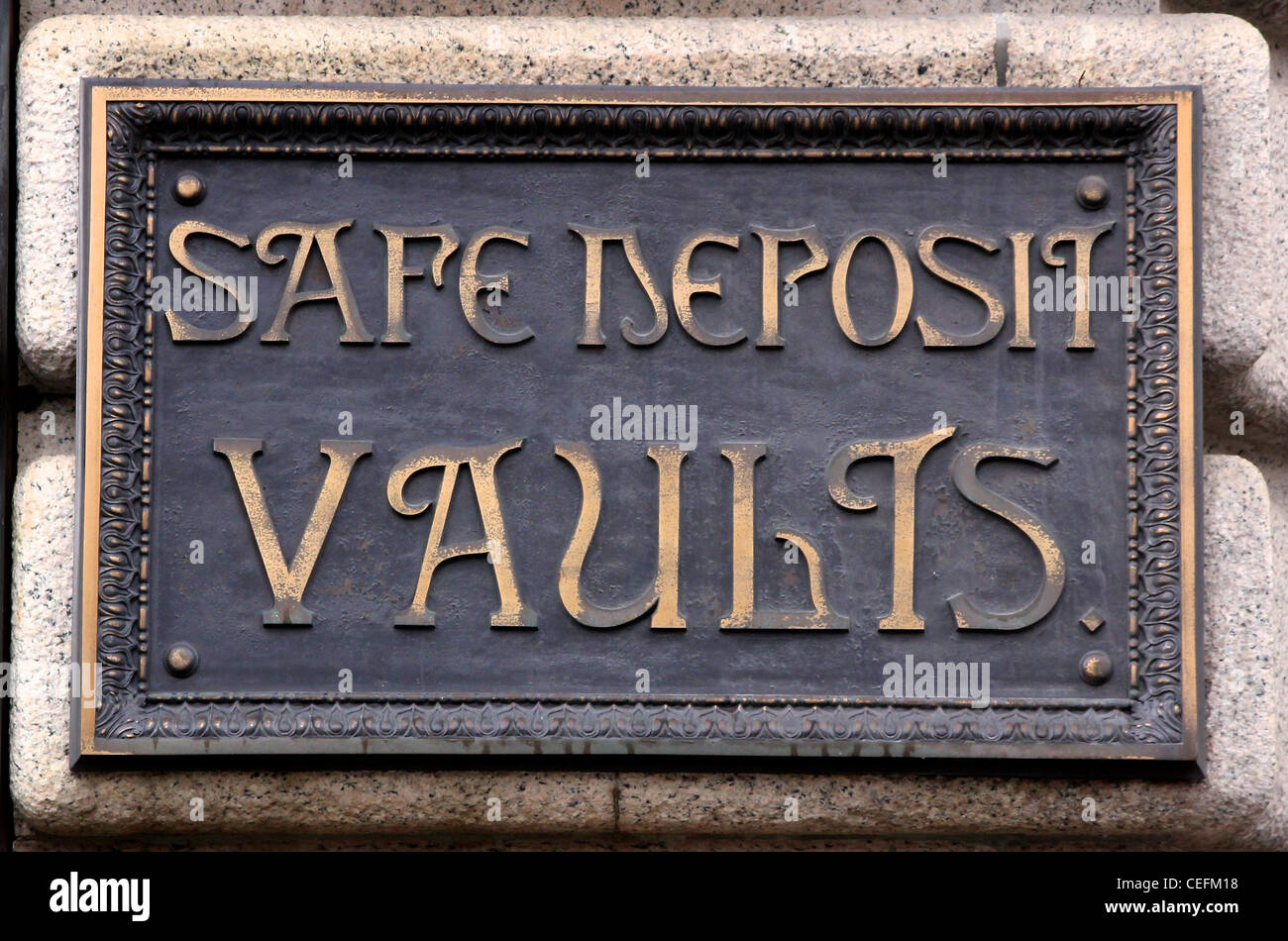 A historic heavy brass sign announcing safe deposit vaults at a former ...