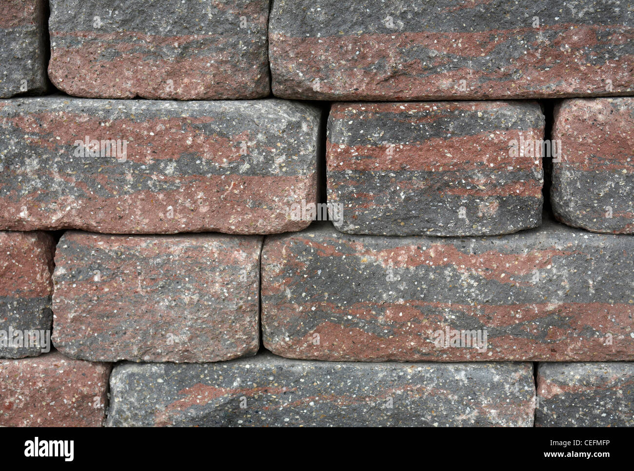 stone wall with reddish marbled stones Stock Photo - Alamy