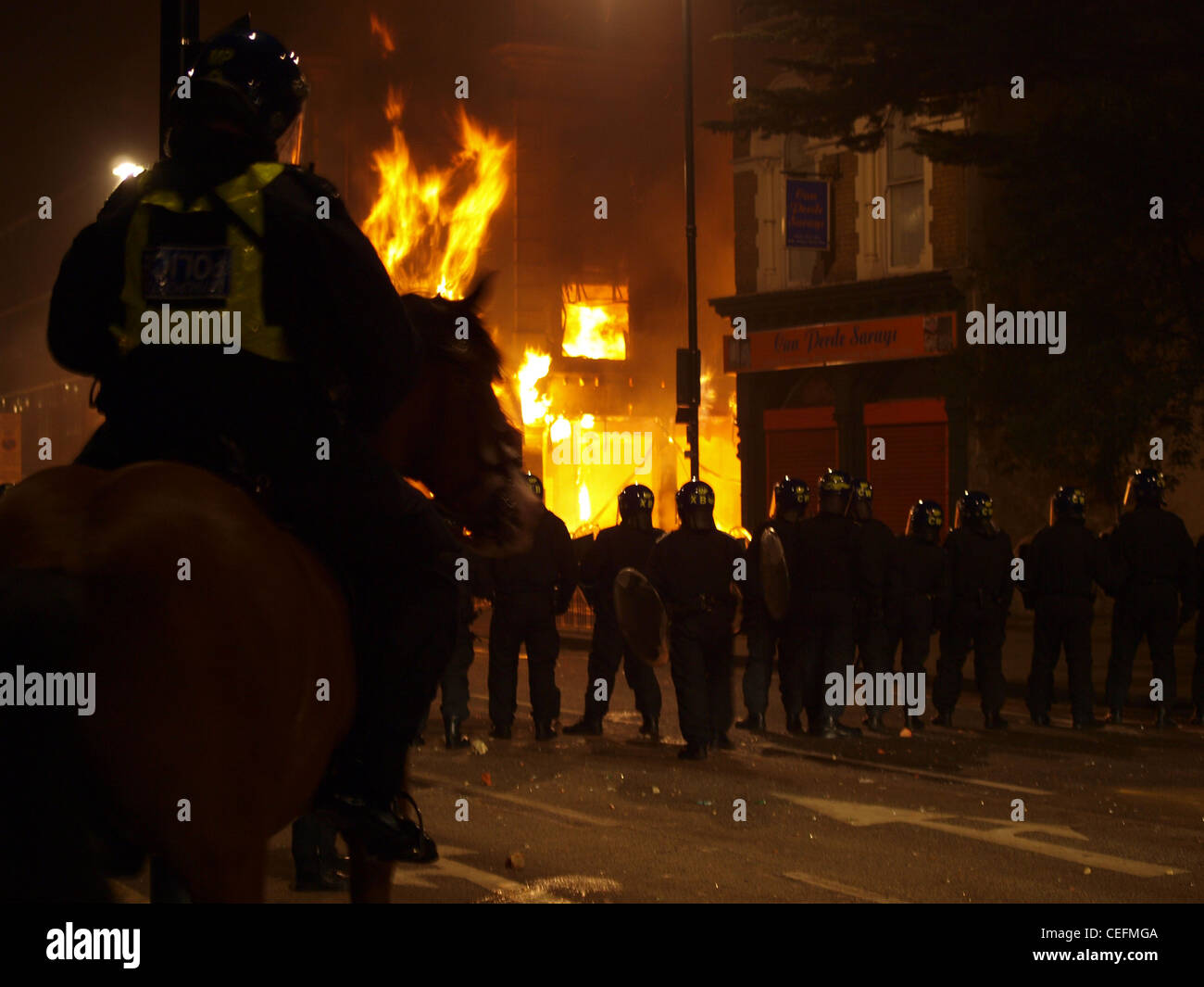 London, UK. 06/08/11. Riot police on horse back prepare to charge at ...