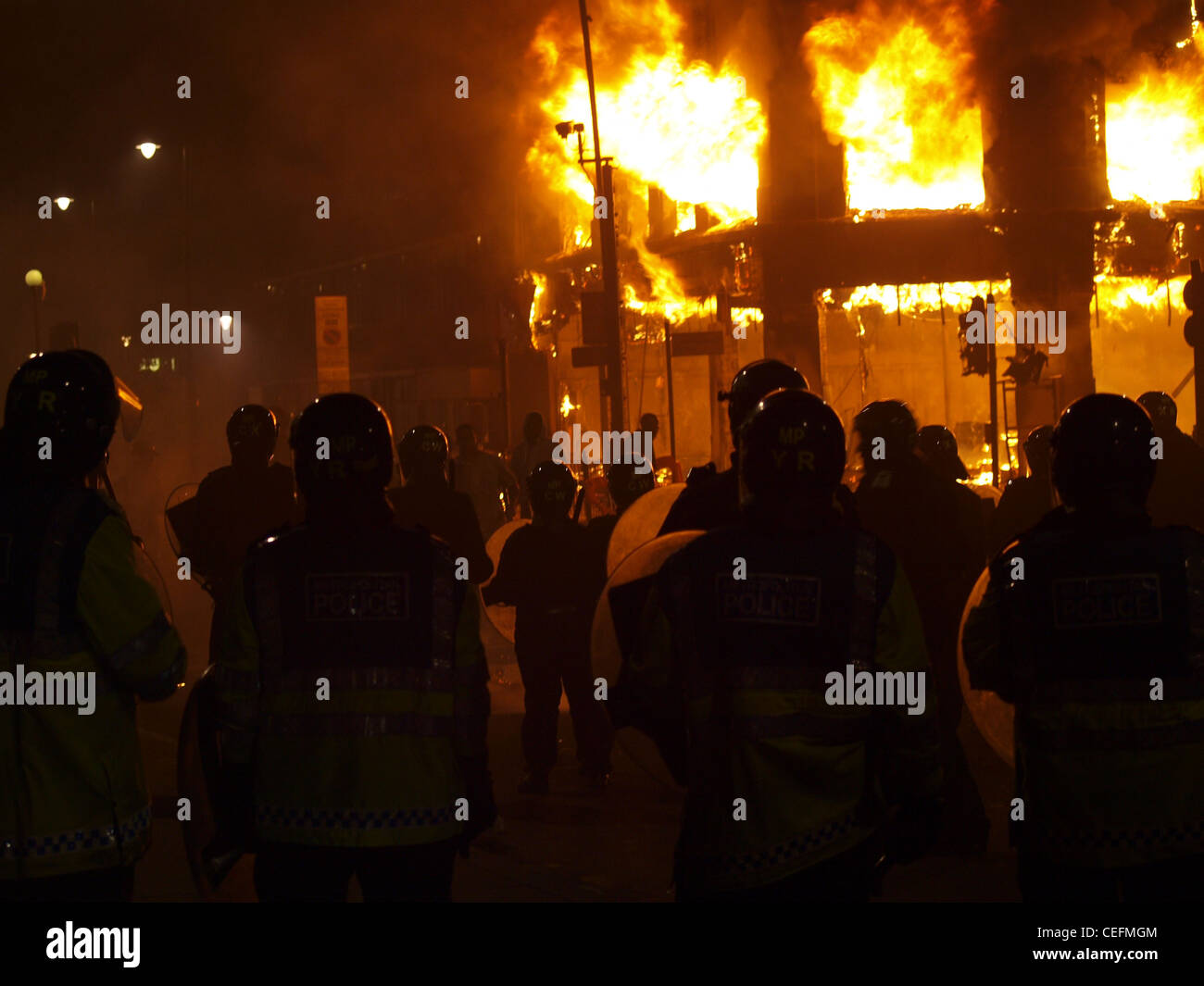 London, UK. 06/08/11. Riot police charge at rioters during the riot in ...