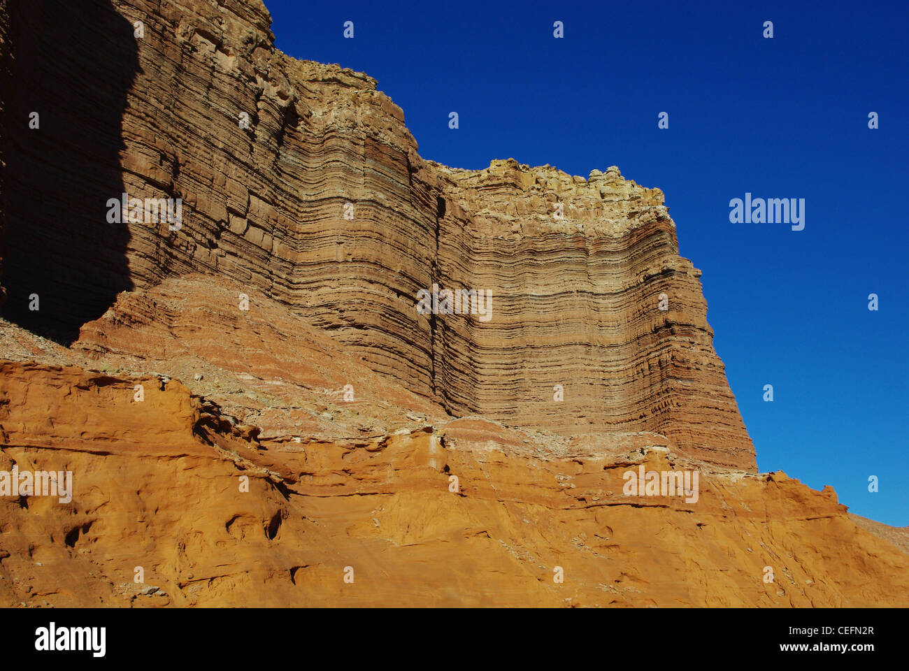 Orange and brown rock formations and walls with deep-blue sky, Glen ...