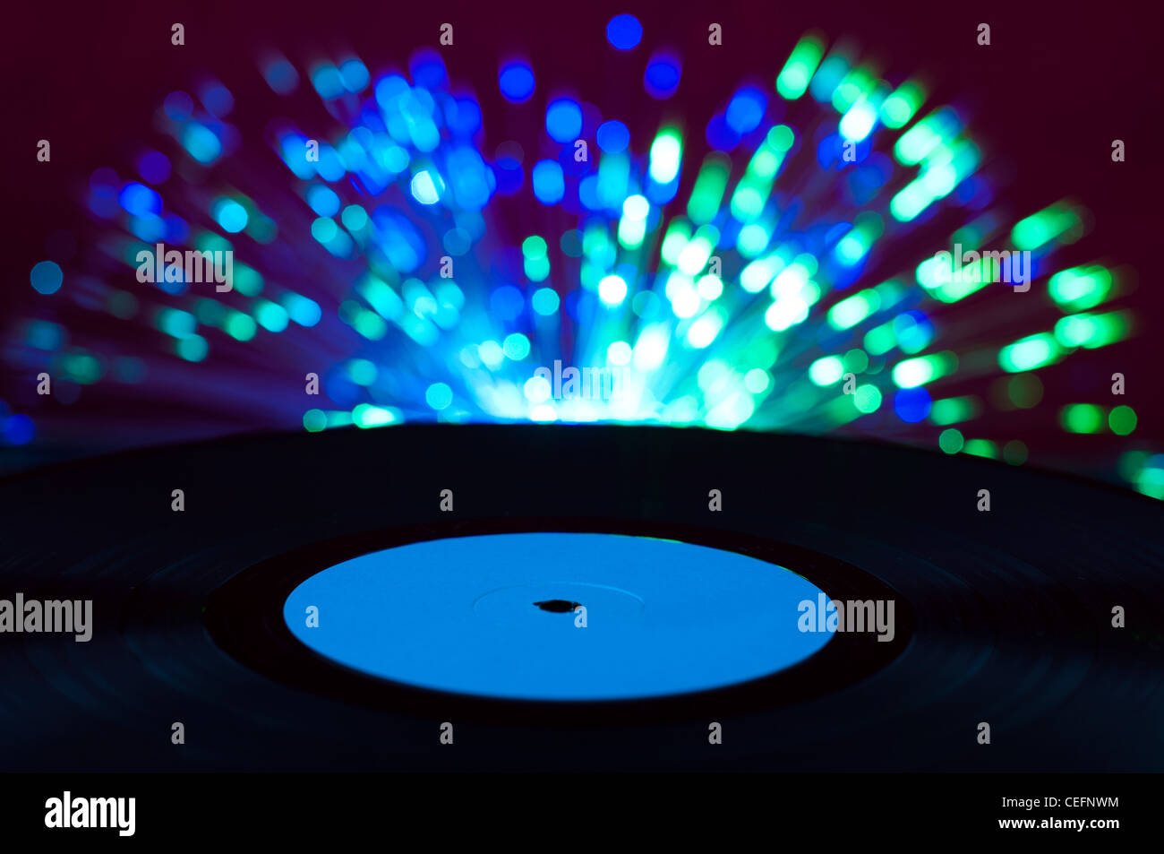 LP vinyl record and disco lights on background Stock Photo - Alamy