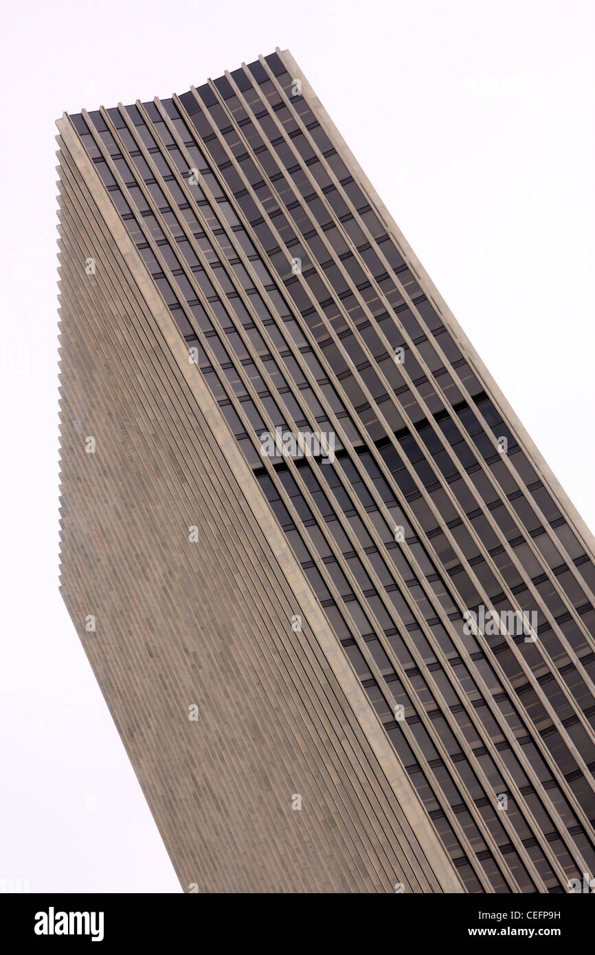 A generic modern office building rising at an angle before an off-white ...