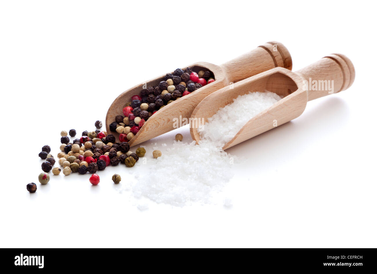 mixed peppercorns and sea salt on wooden shovels, white background ...