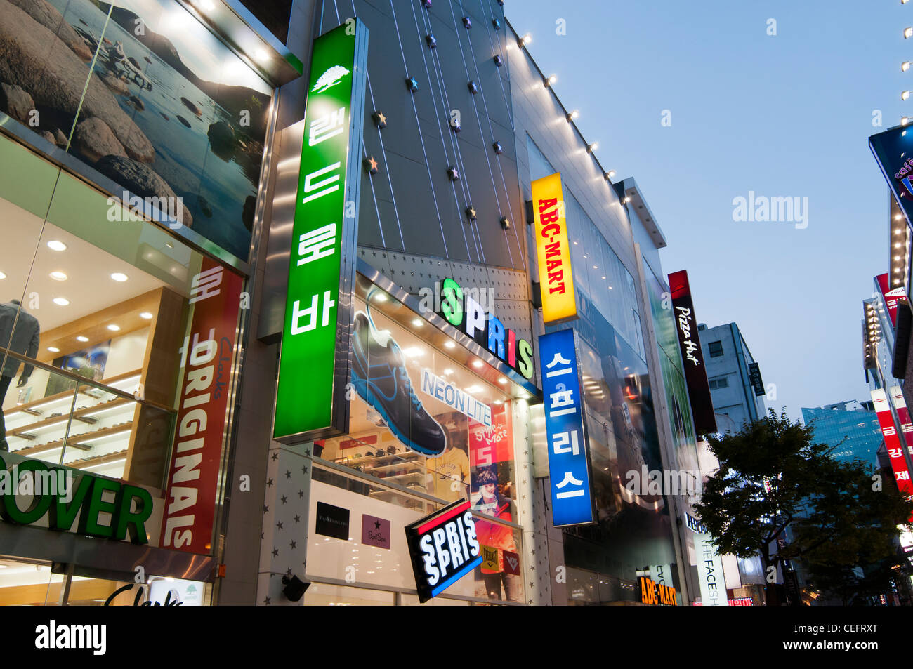 Illuminated shop signs in the evening in the popular shopping district ...