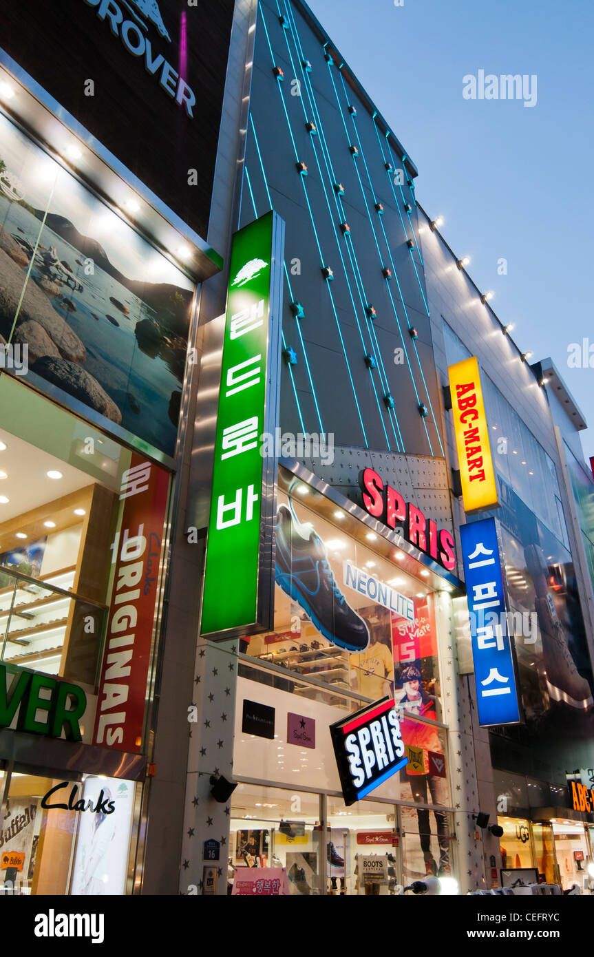 Illuminated shop signs in the evening in the popular shopping district ...