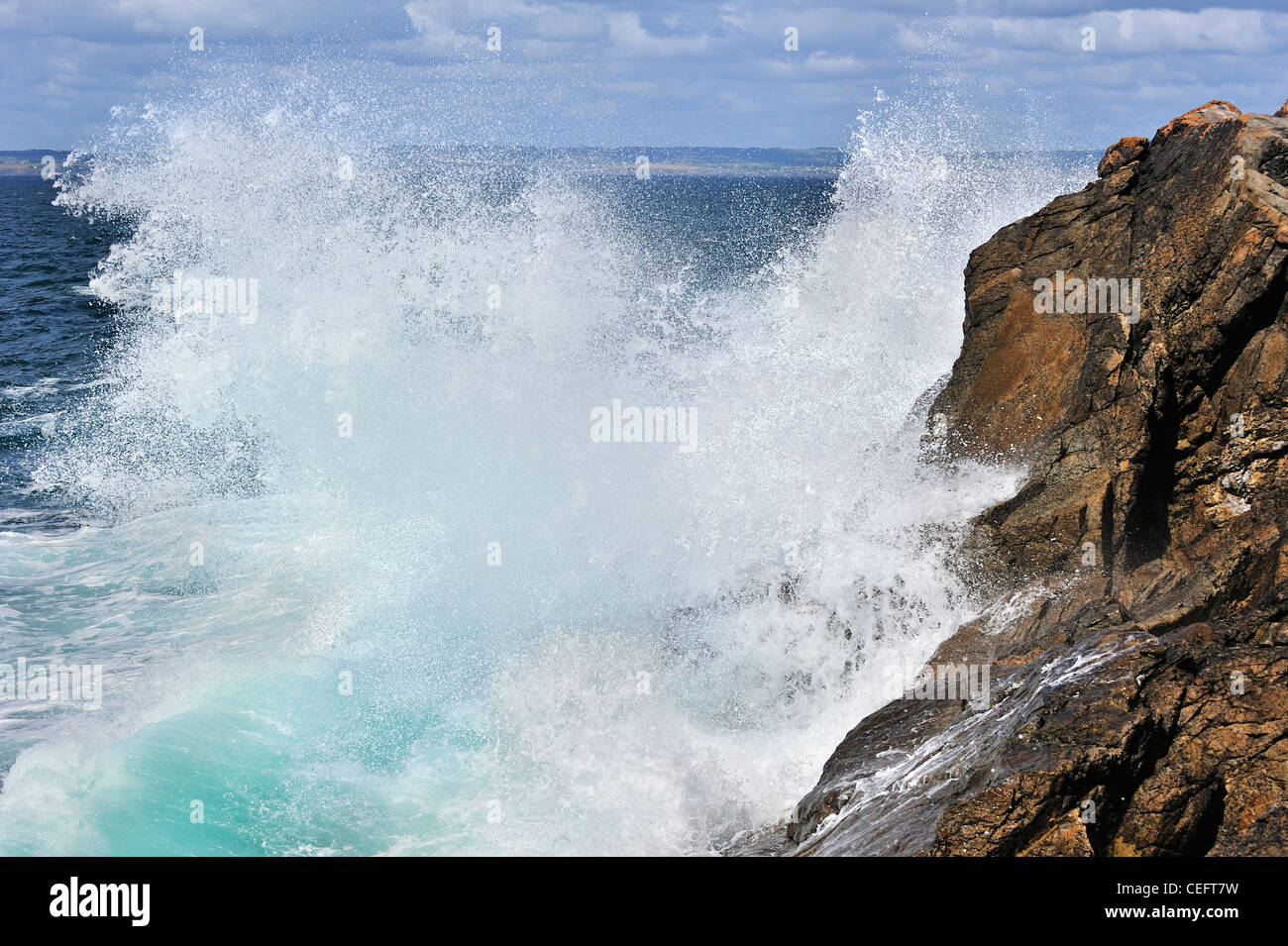 Waves crashing into rocks of cliff along the Brittany coast, France ...