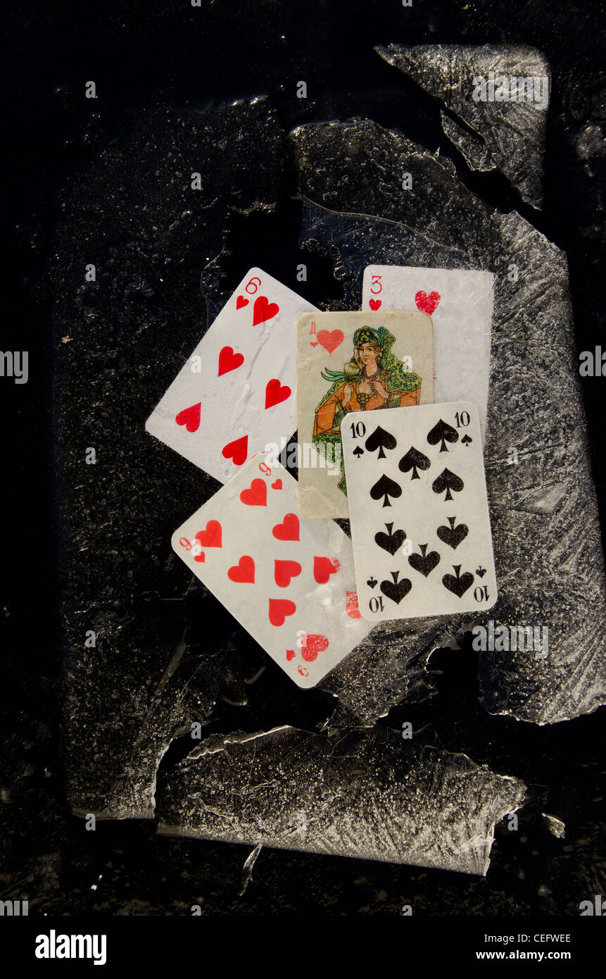 playing cards in the winter ice black background Stock Photo - Alamy