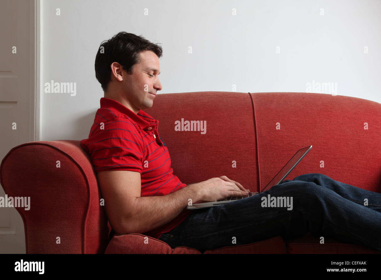 Profile of a single man using a laptop Stock Photo - Alamy