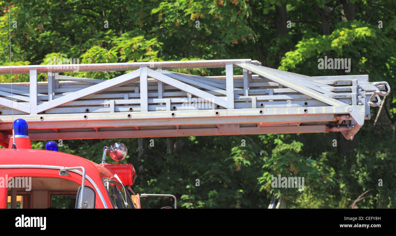 Ladder of a fire truck on the blue sky, emergency light on firetruck ...