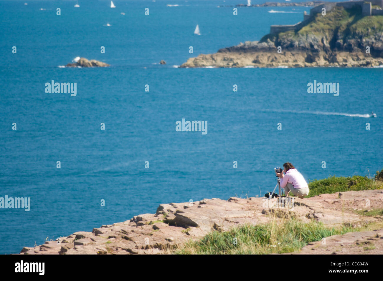camera operator, cameraman in nature taking pictures a beautiful sea. A ...
