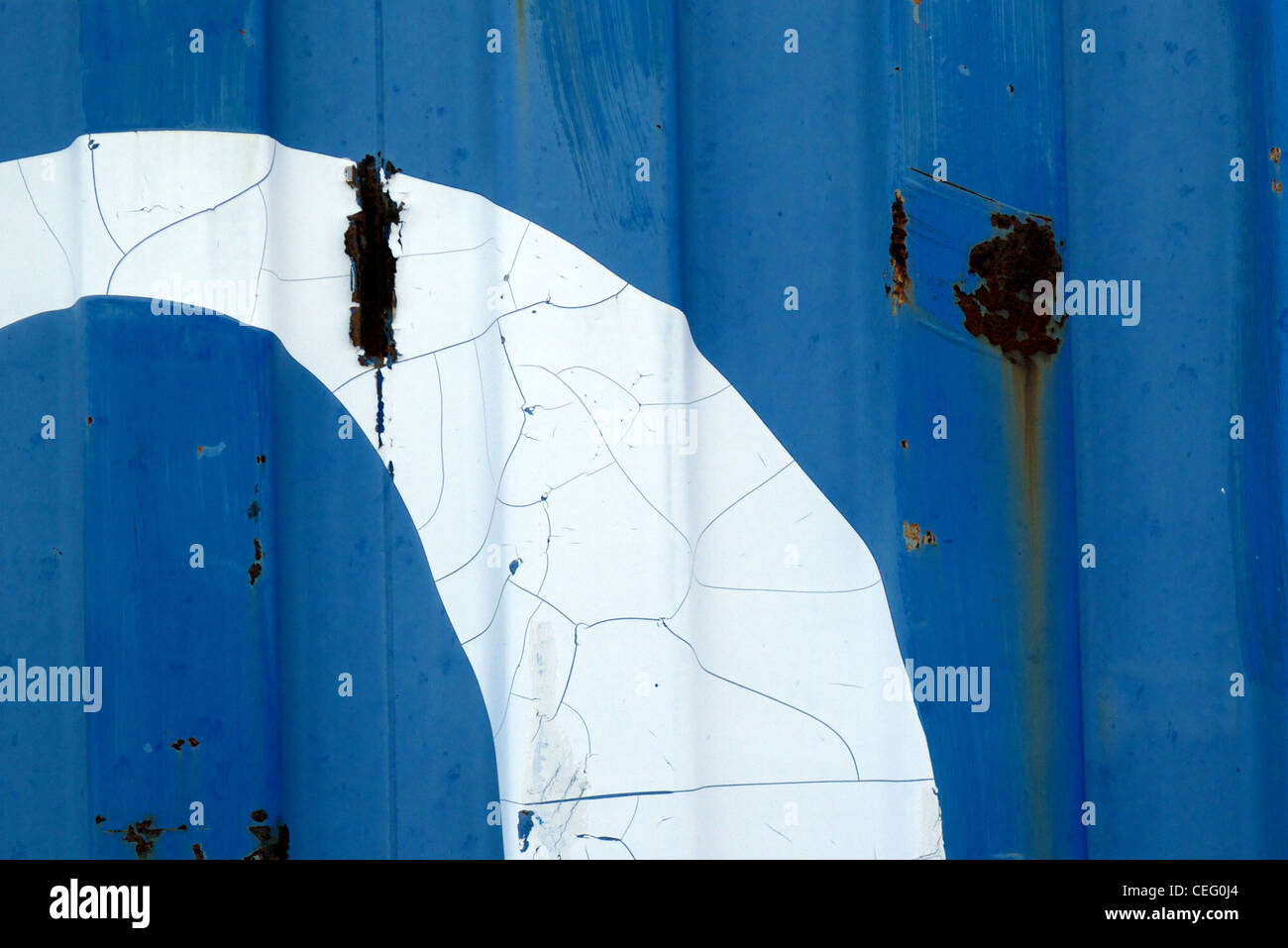 Corrugated metal surface of a shipping container with white painted ...