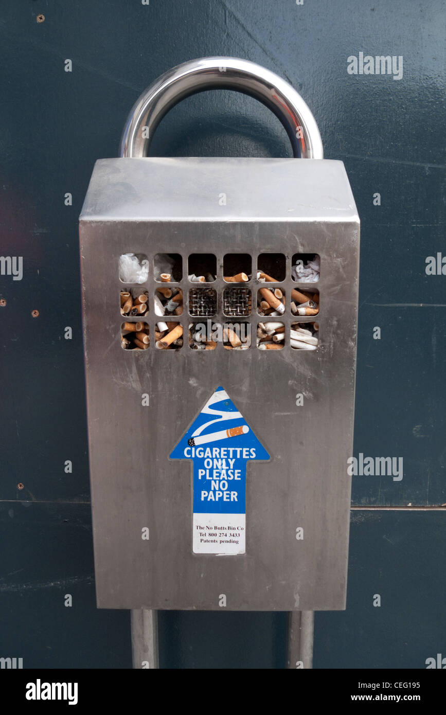Cigarette butts in a disposal bin on a London street Stock Photo - Alamy