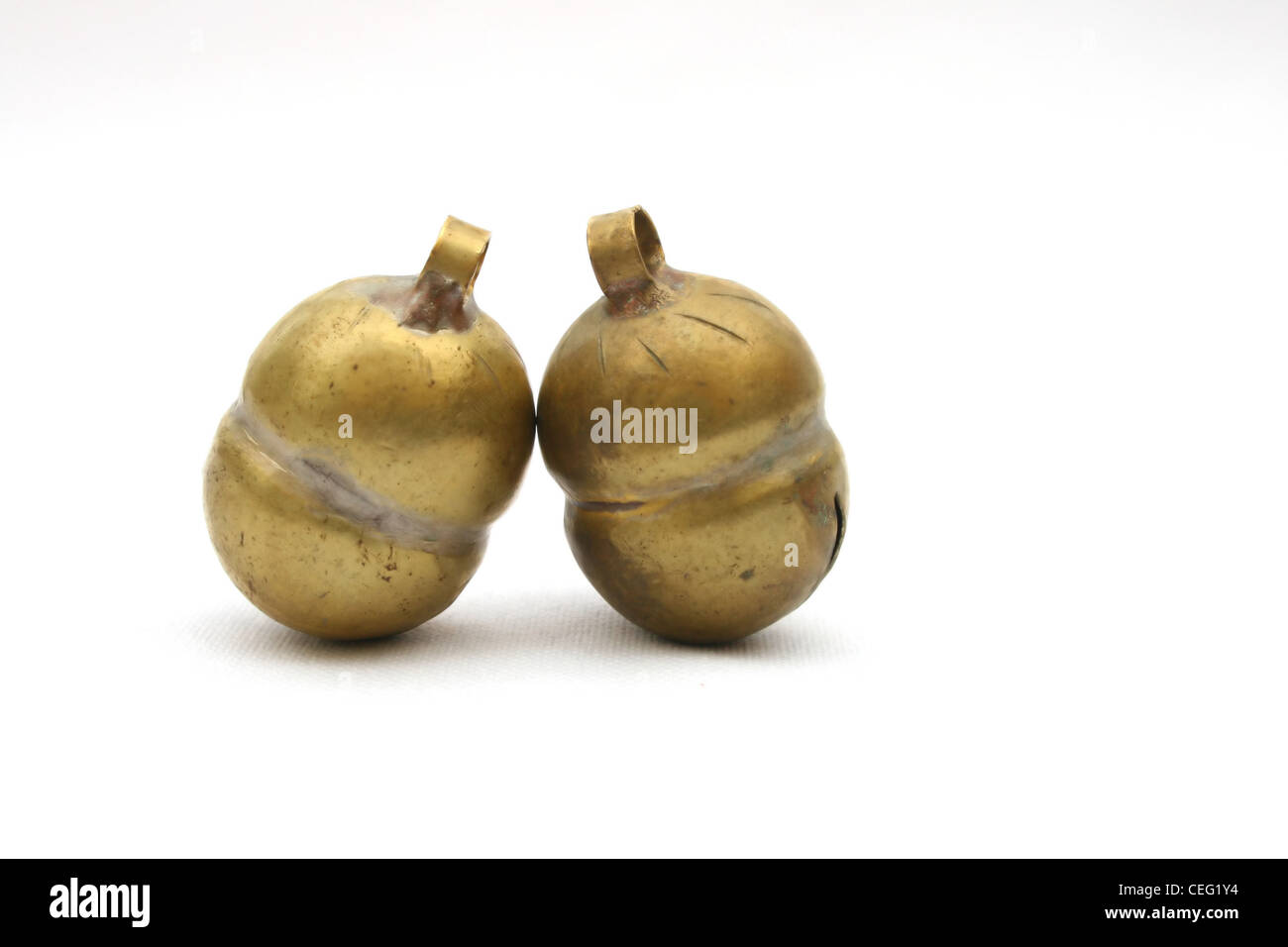 Pair of falconry bells on a plain background Stock Photo - Alamy