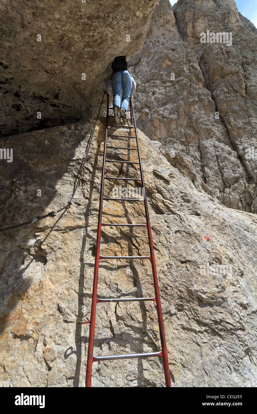woman is climbing on metal ladder in Italian Dolomites Stock Photo - Alamy