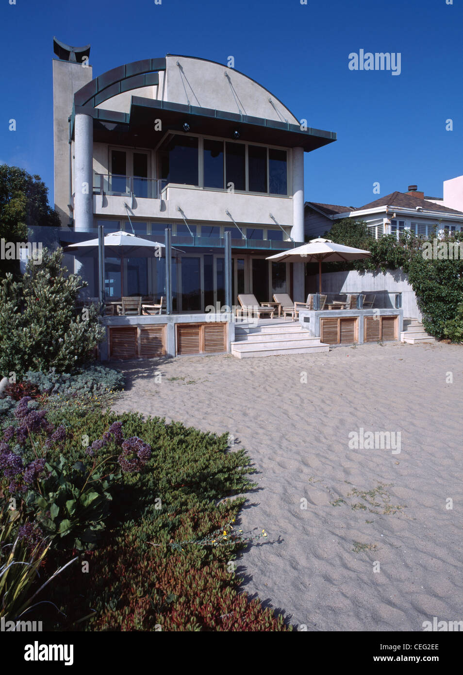 Modern beach house with loungers and white umbrellas on veranda Stock ...