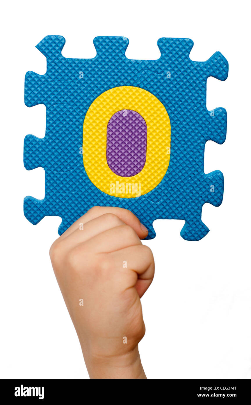 Children hand holding the number Zero. White isolated multicolor number ...